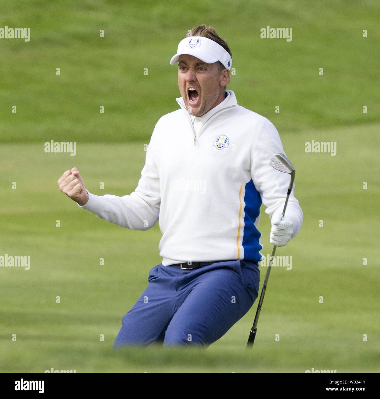 Europe's Ian Poulter celebrates a chip in the morning fourball match ...