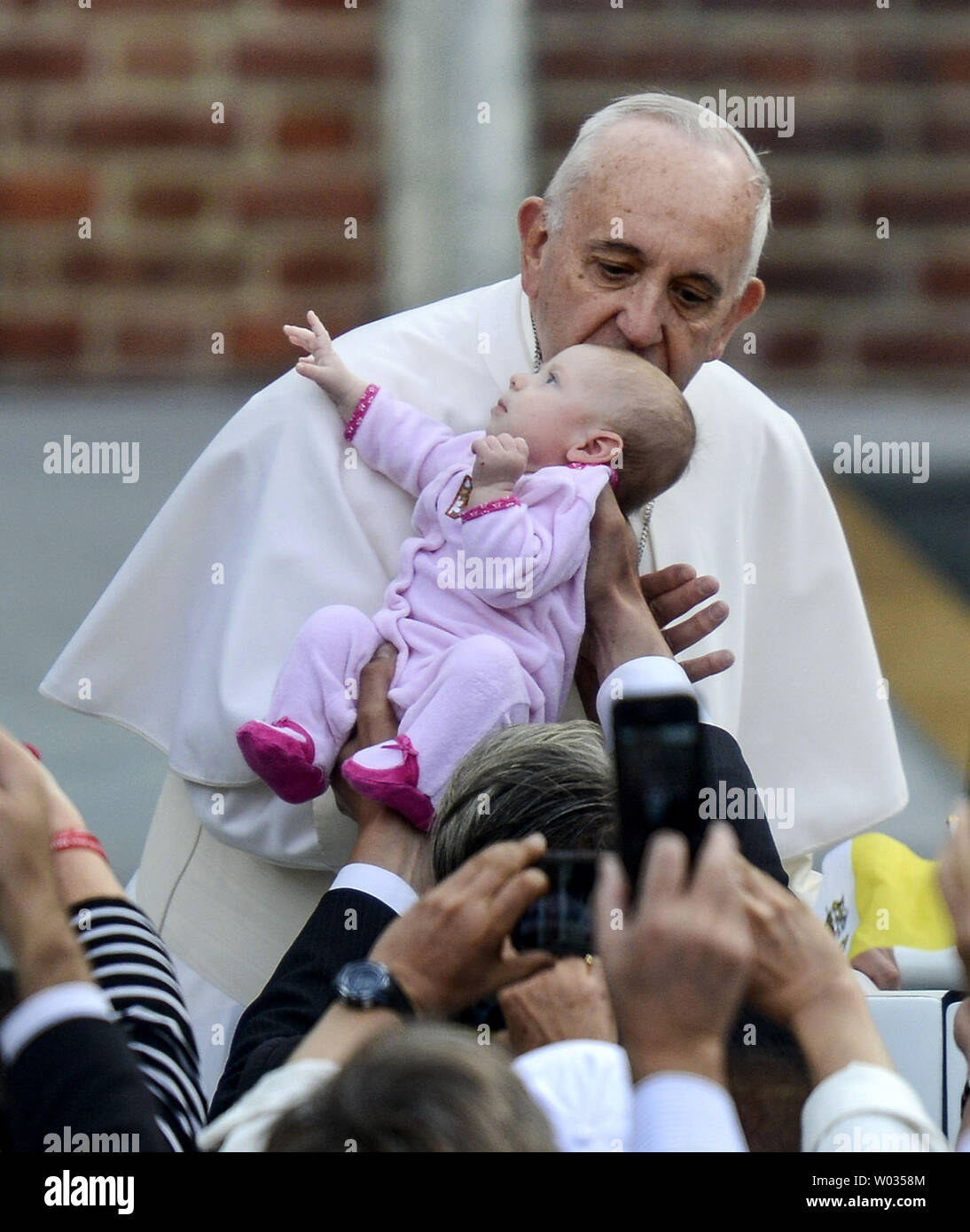 Pope Francis kisses a baby as he makes a visit to Independence Hall in ...