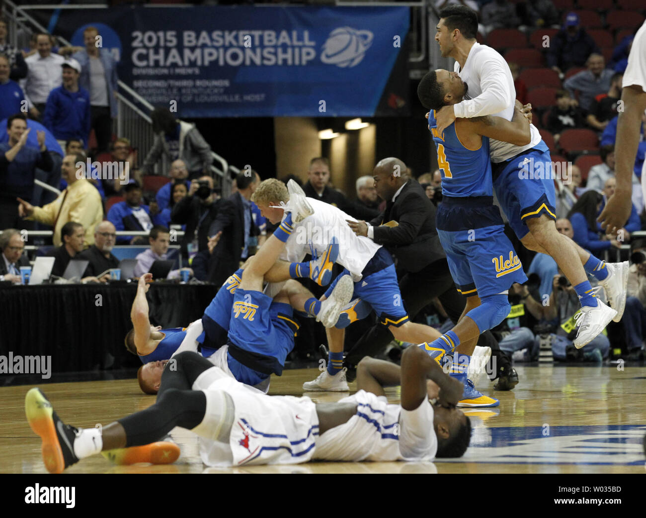 The UCLA Bruins basketball team celebrate after defeating the SMU ...