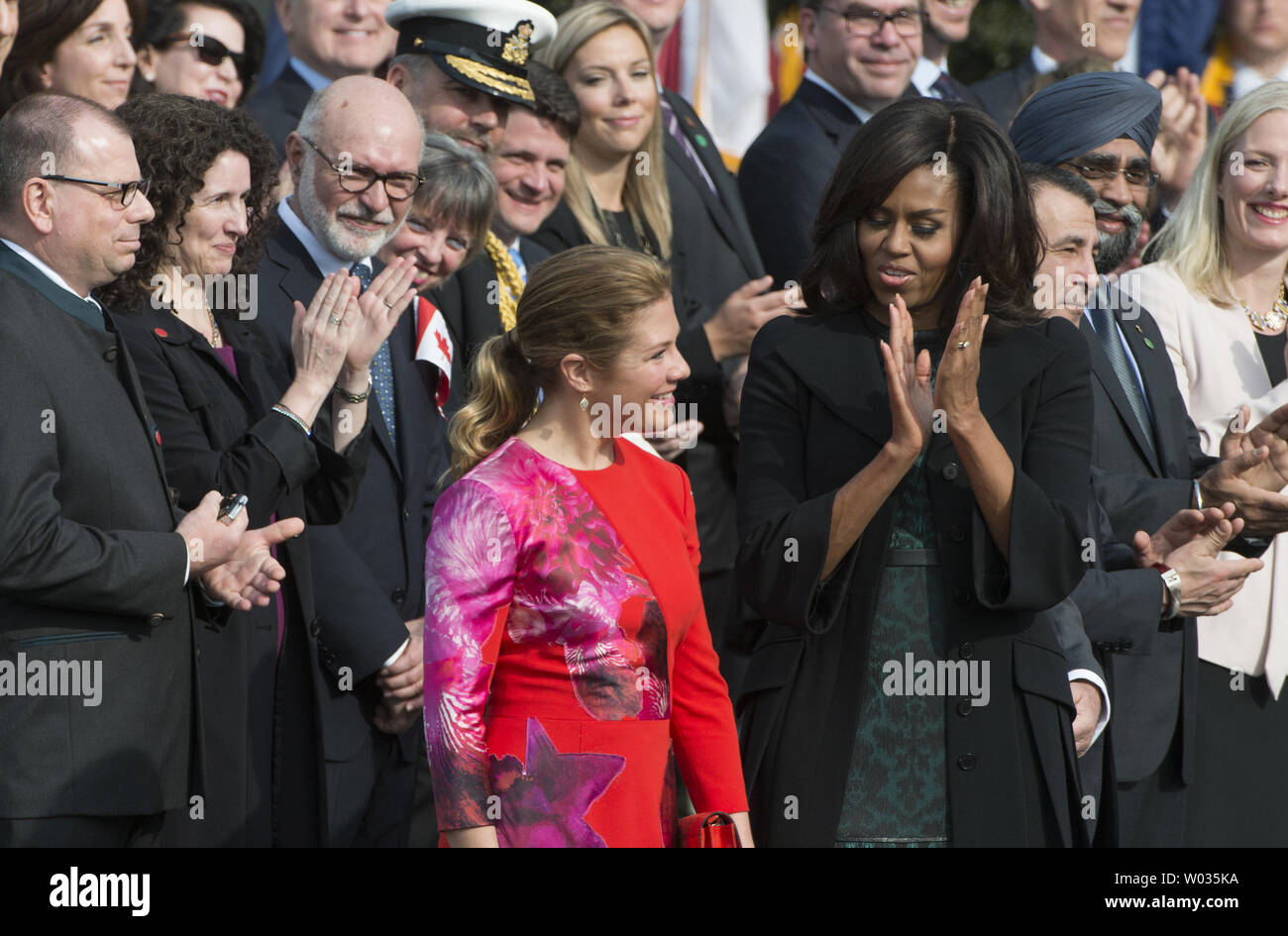 U.S. first lady Michelle Obama applauds as Canadian first lady Sophie ...