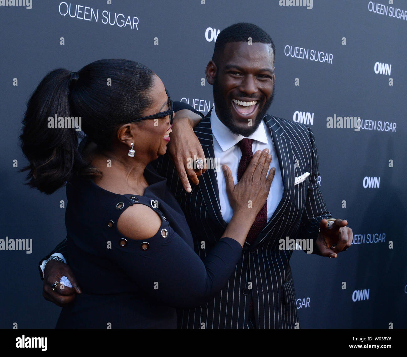 Executive producer Oprah Winfrey (L) and cast member Kofi Siriboe ...