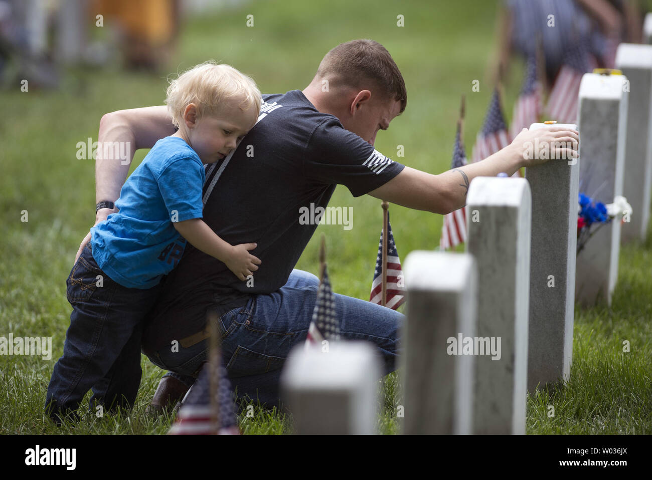Marine Sgt. J.W. Dickerson is hugged by his son Liam, 2, as he visits ...
