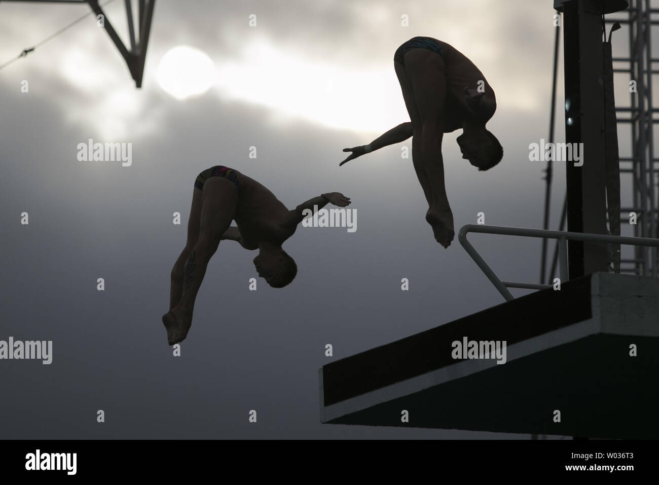 Tandem divers practice from the 10-meter platform in the Maria Lenk ...