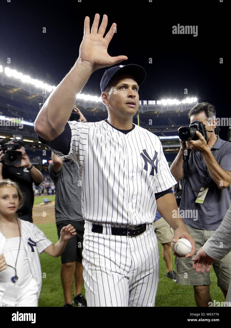 New York Yankees Alex Rodriguez walks off of the field with daughters Natasha and Ella after his ...