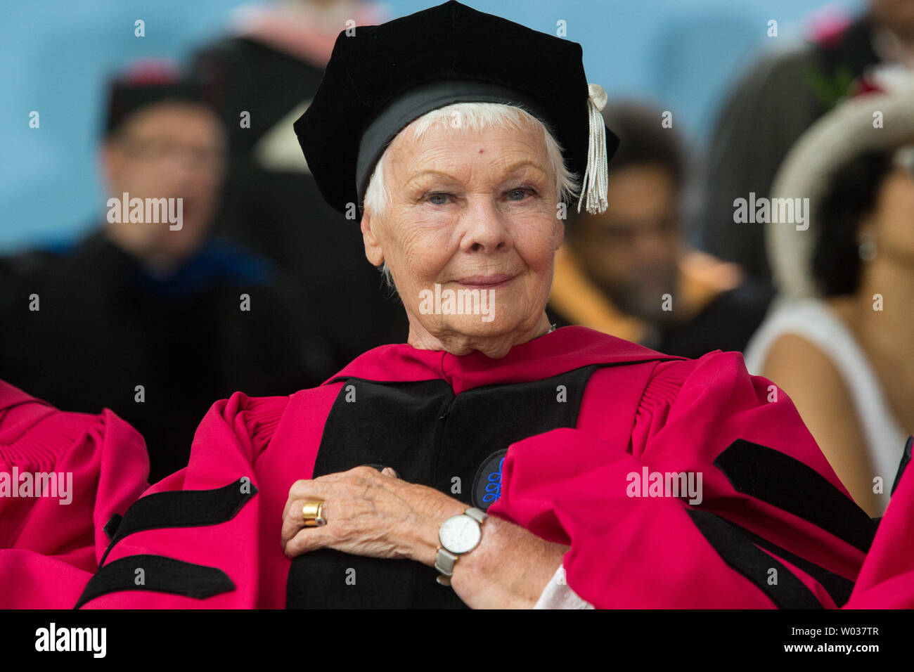 Actress Dame Judy Dench adjusts her robe while awaiting the start of ...