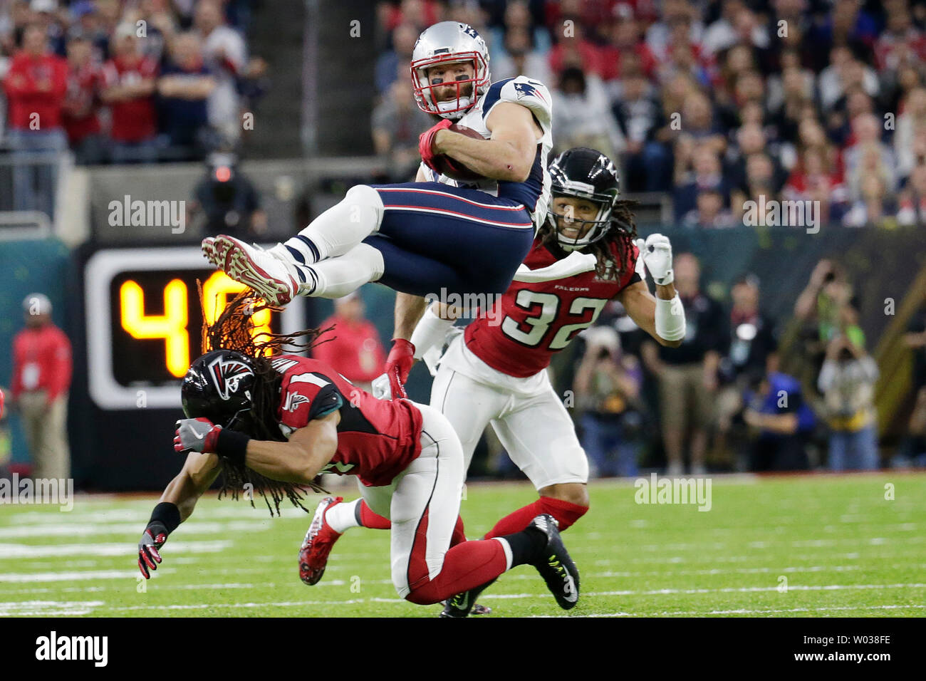New England Patriots wide receiver Julian Edelman (11) is flipped in ...
