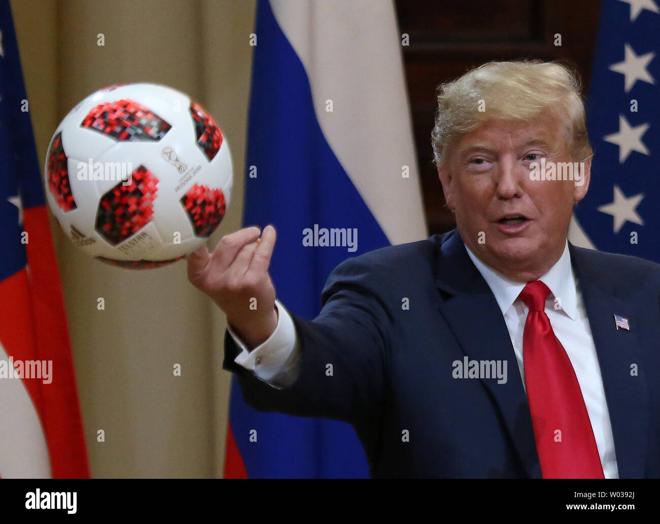 U.S. President Donald Trump throws a soccer ball he received from ...