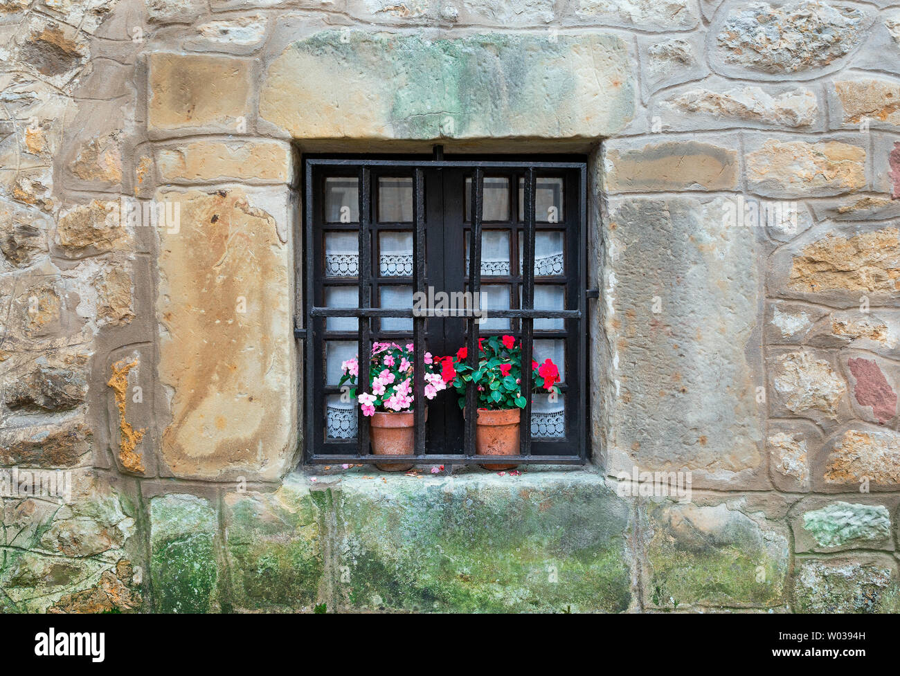 stone wall and window with bars and flowers Stock Photo - Alamy