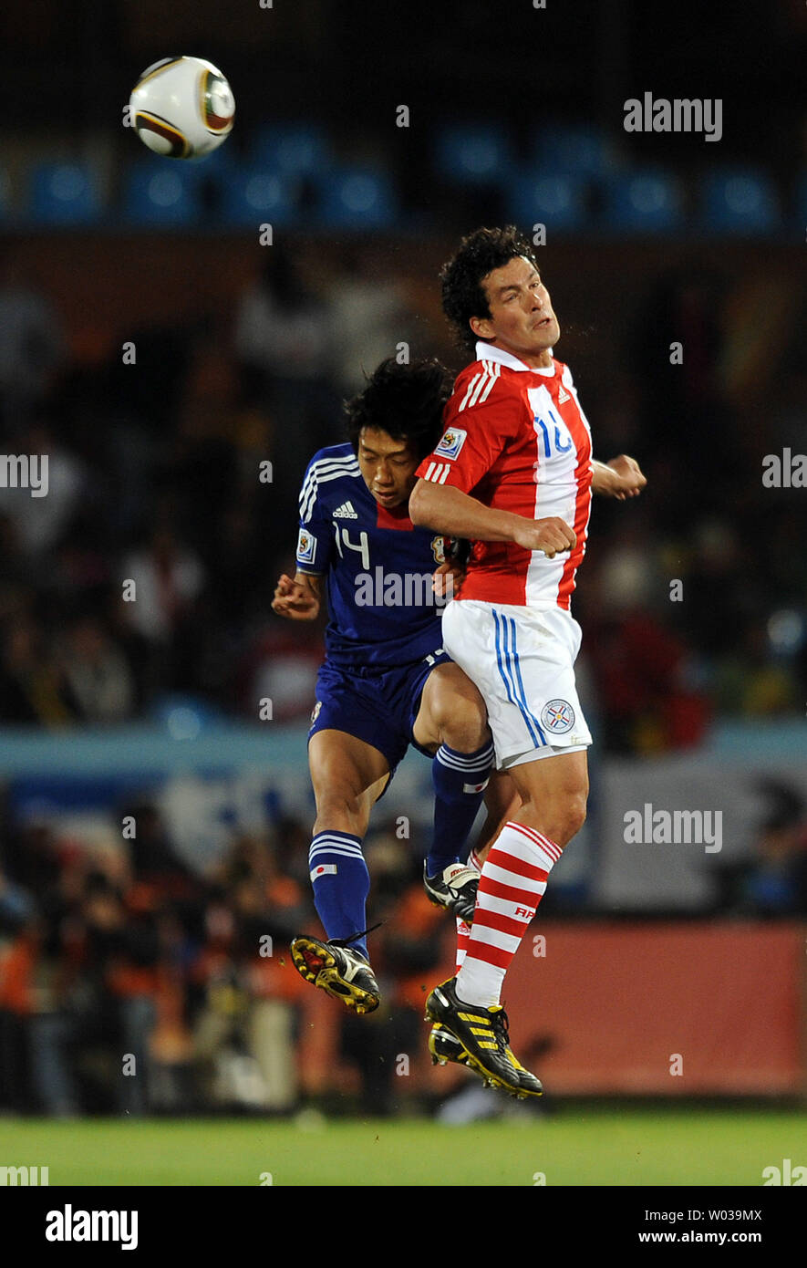Cristian Riveros of Paraguay and Kengo Nakamura of Japan attempts to ...