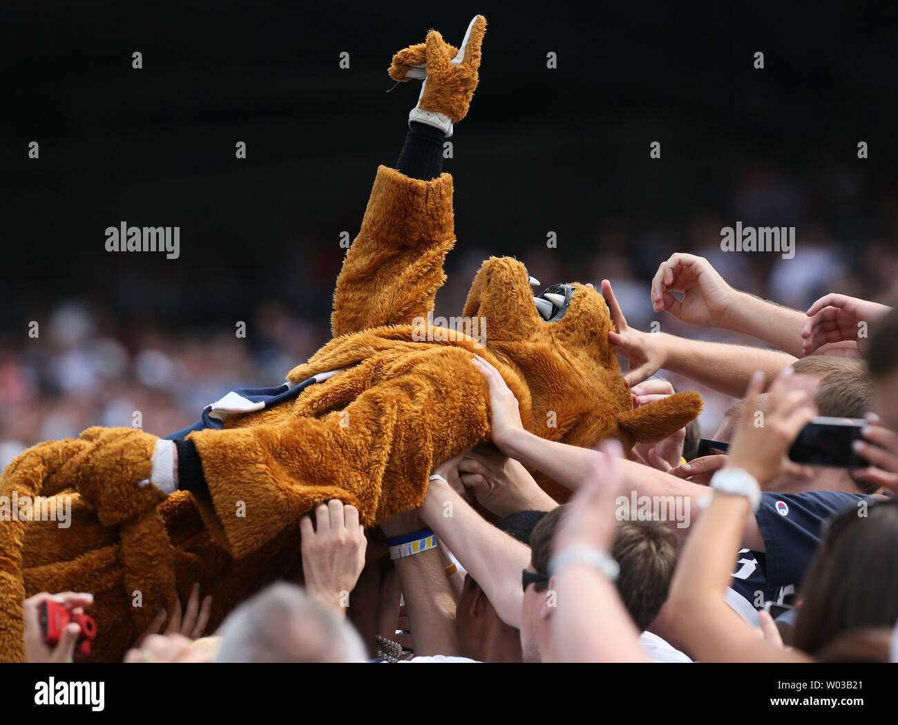 The Lion mascot takes a ride as the students pass him up through the ...