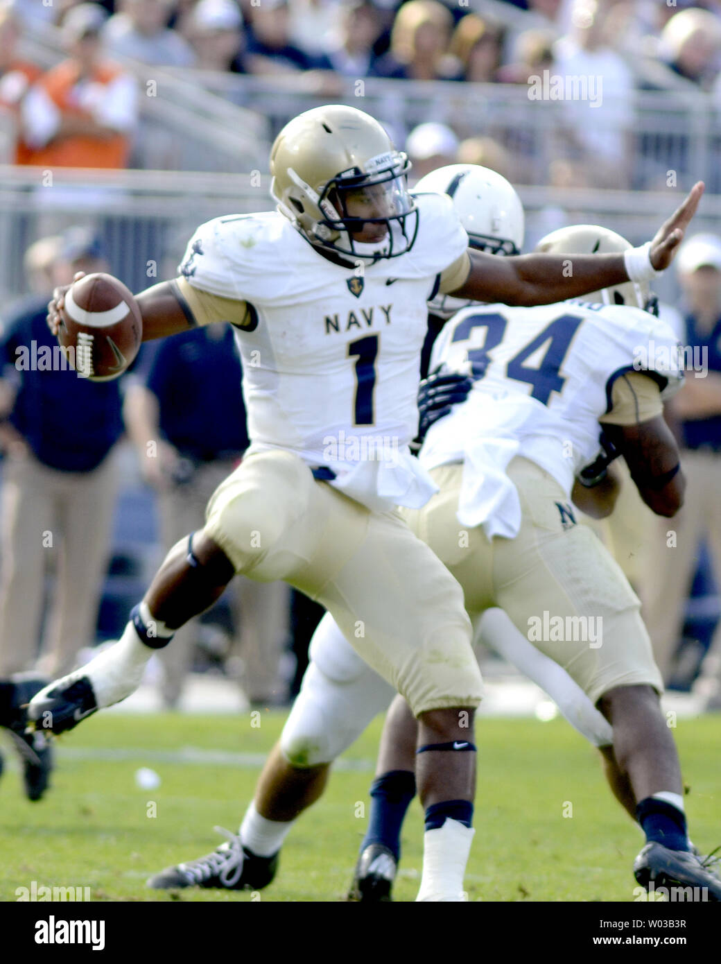 Navy quarterback Trey Miller regains his balance and runs four yards ...