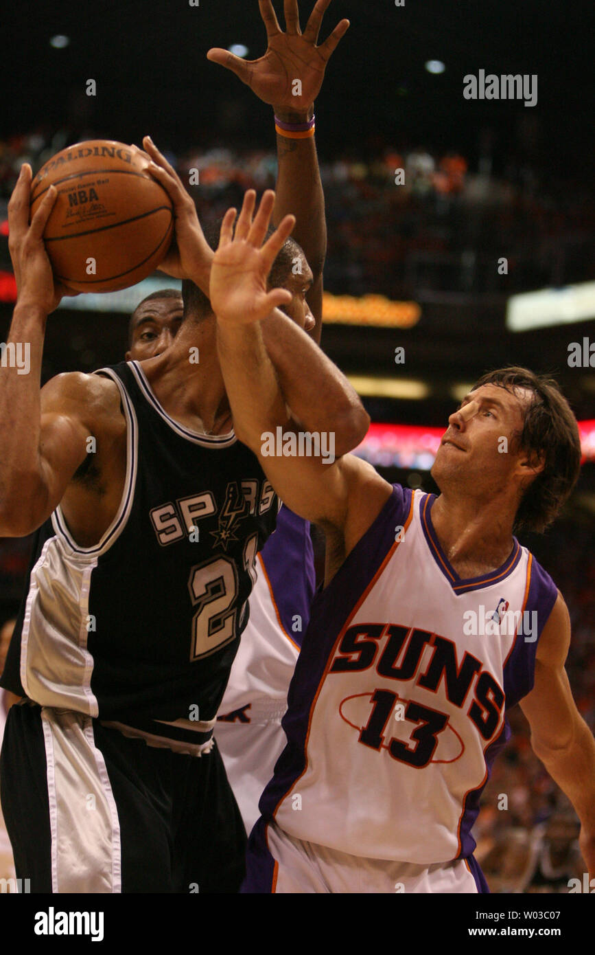 San Antonio Spurs forward Tim Duncan (left) is closely guarded by ...