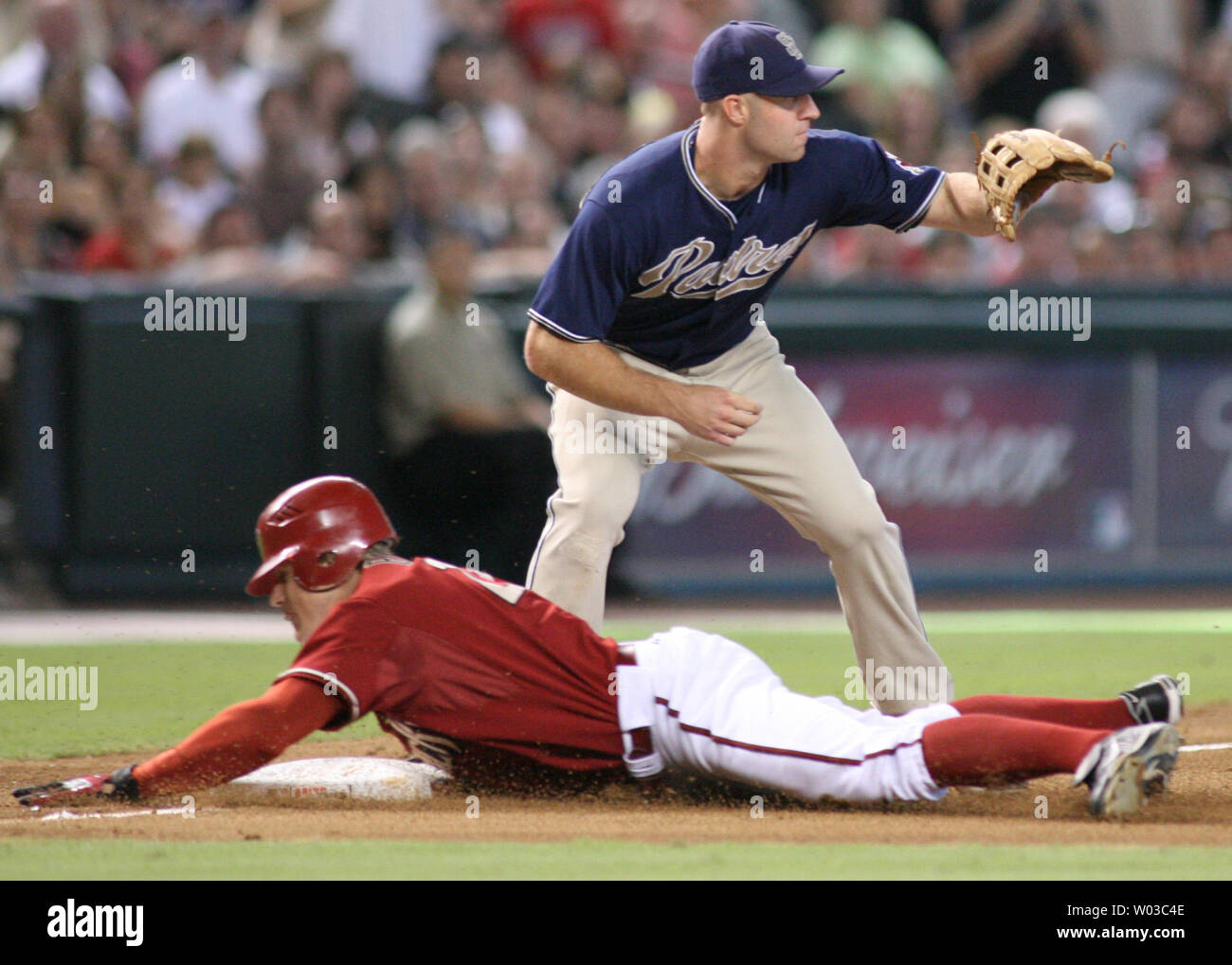 Arizona Diamondbacks Eric Byrnes slides safely into third base for a ...