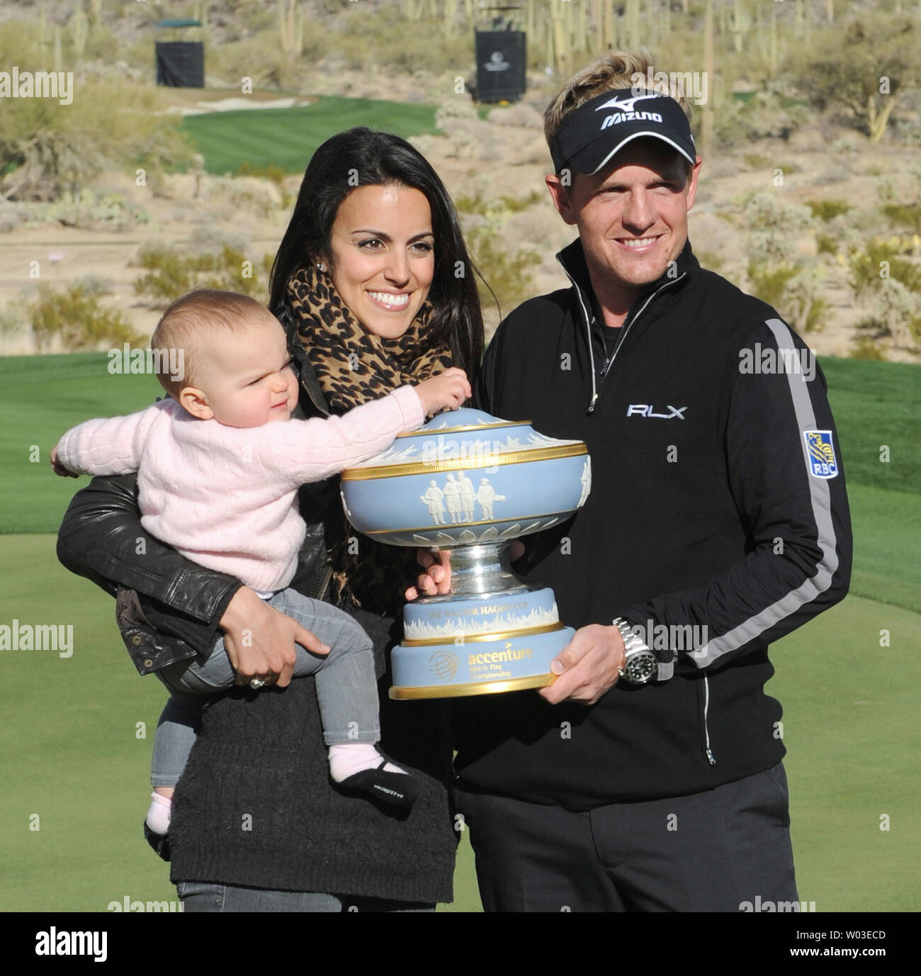 Luke Donald (R) of England holds the trophy with his wife Diane (C) and ...
