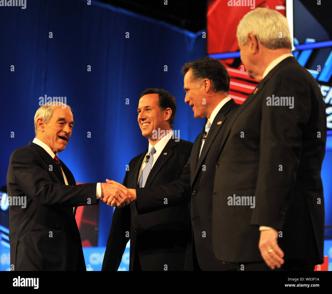 Ron Paul, Rick Santorum, Mitt Romney, and Newt Gingrich (L-R) shake ...