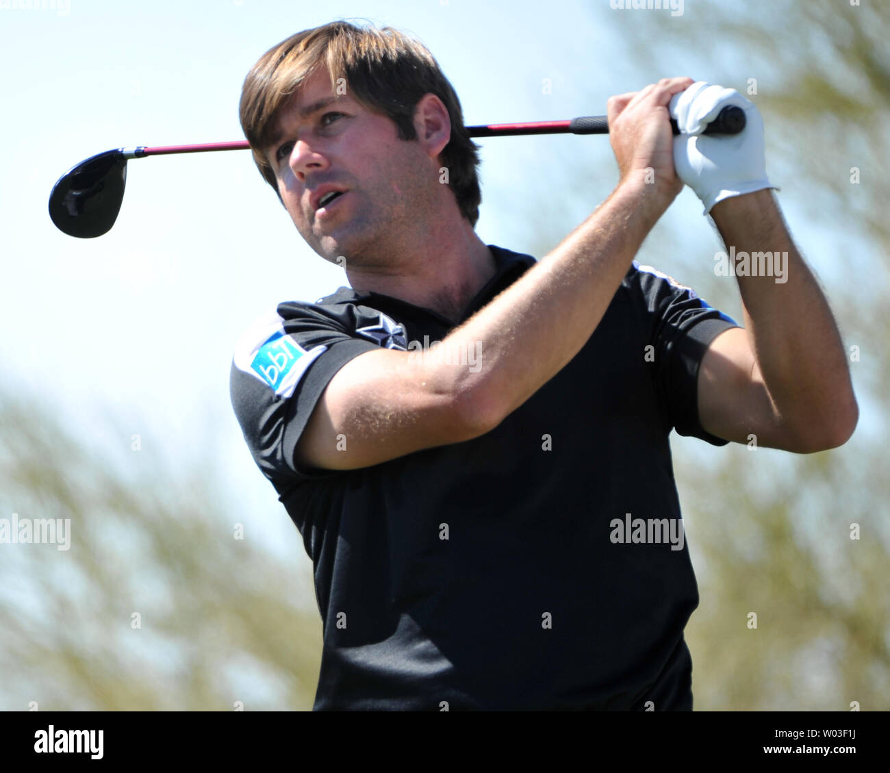 Robert Rock of England follows the flight of his ball after teeing off ...