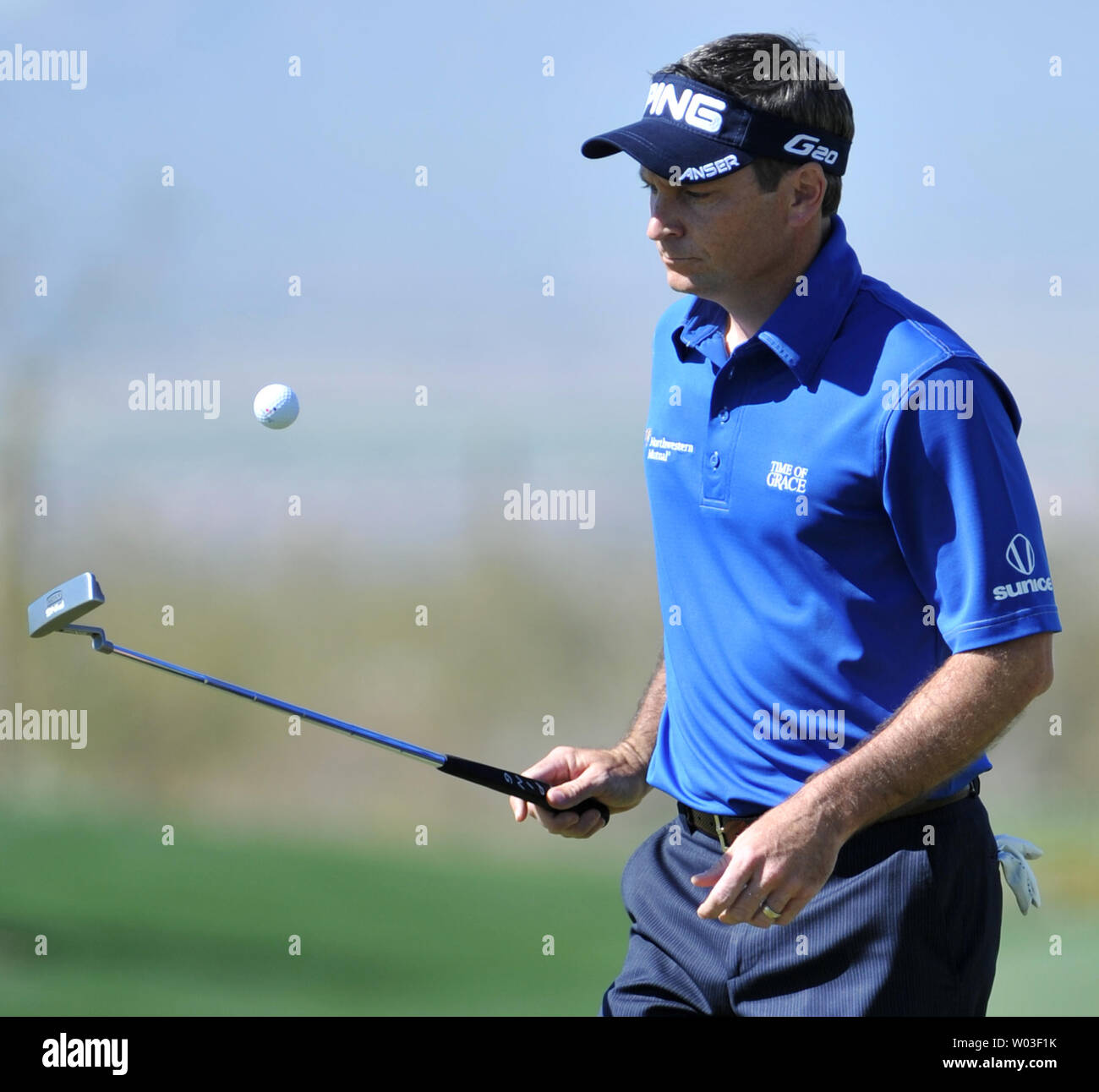 American Mark Wilson picks up his ball with his putter on the eighth ...