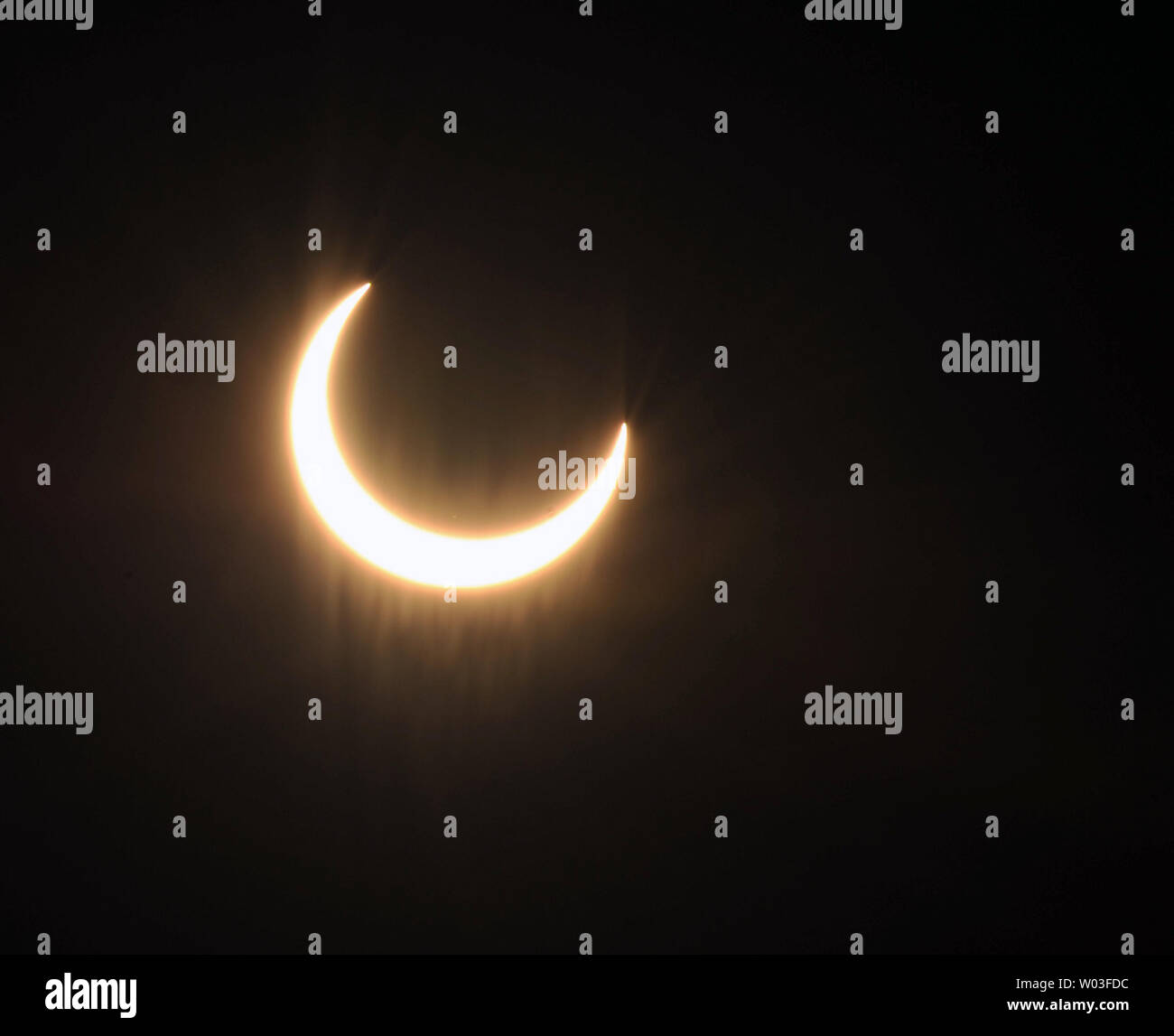 The Sun is partially covered by the Moon in this image of the Solar ...
