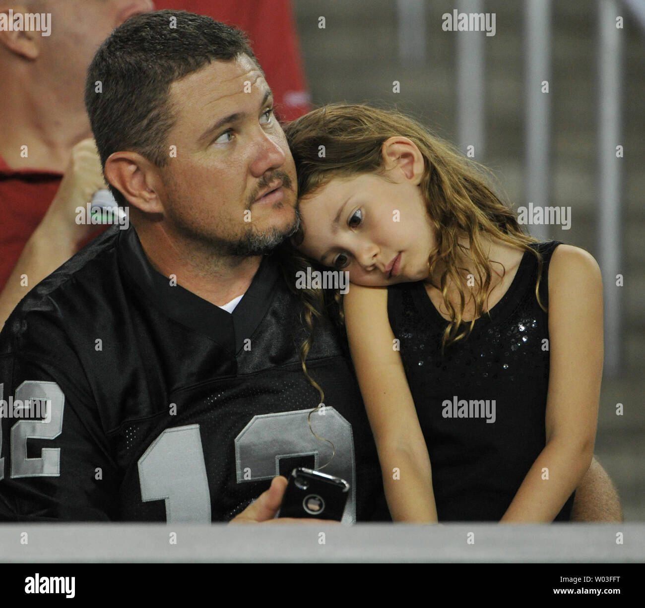 An Oakland Raiders fan and his daughter attend the Raiders-Arizona ...