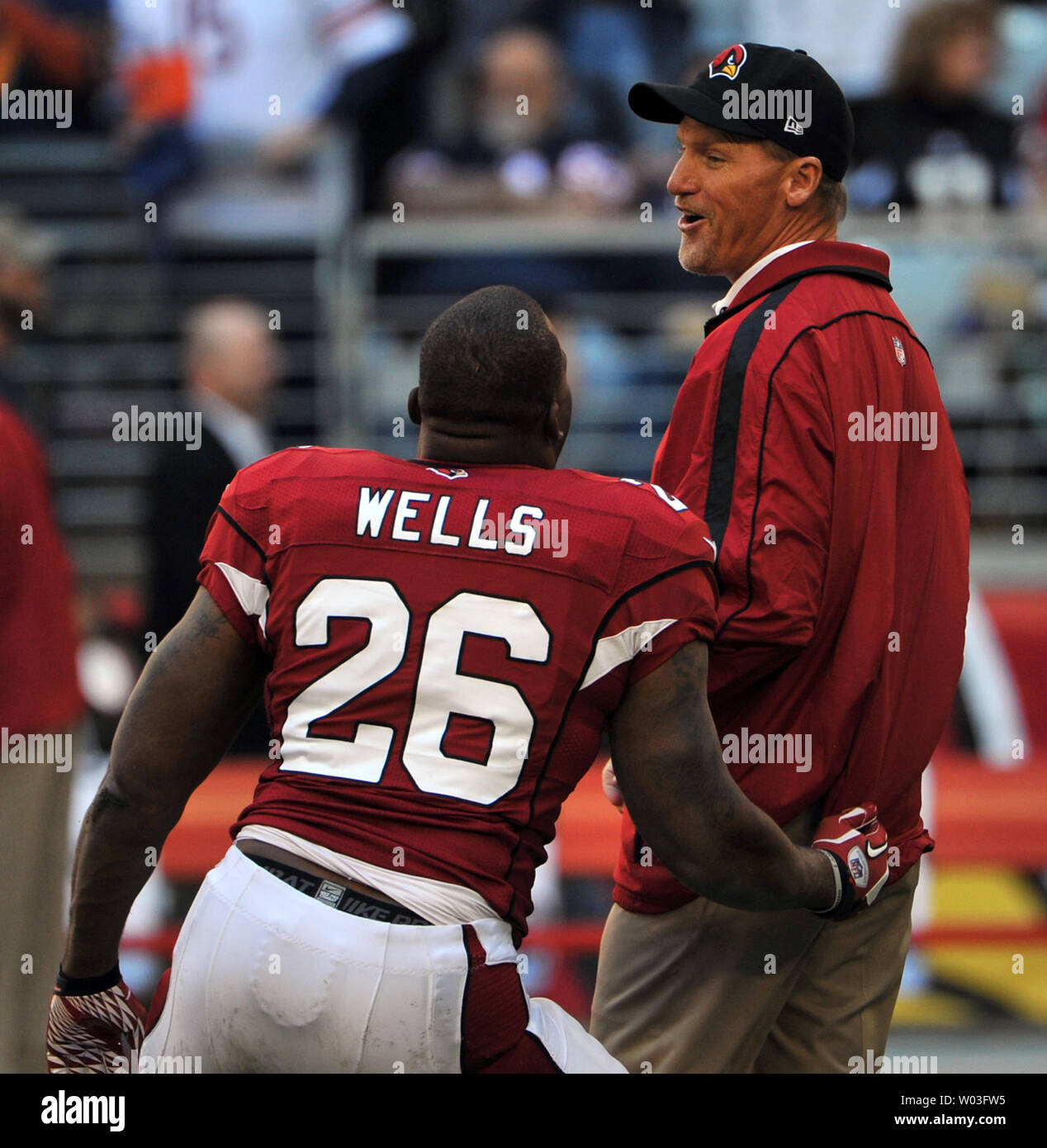 Arizona Cardinals Beanie Wells (L) gets a reaction from head coach Ken ...