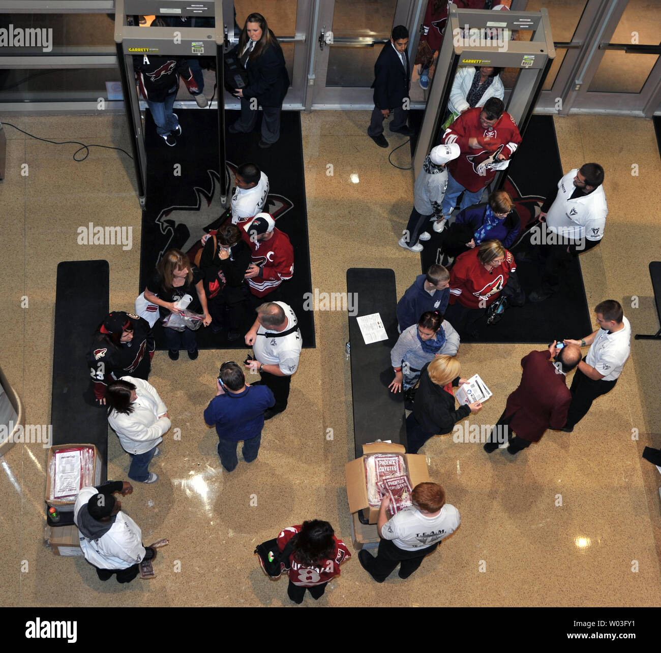 Phoenix Coyotes fans pass through security before the game between the ...