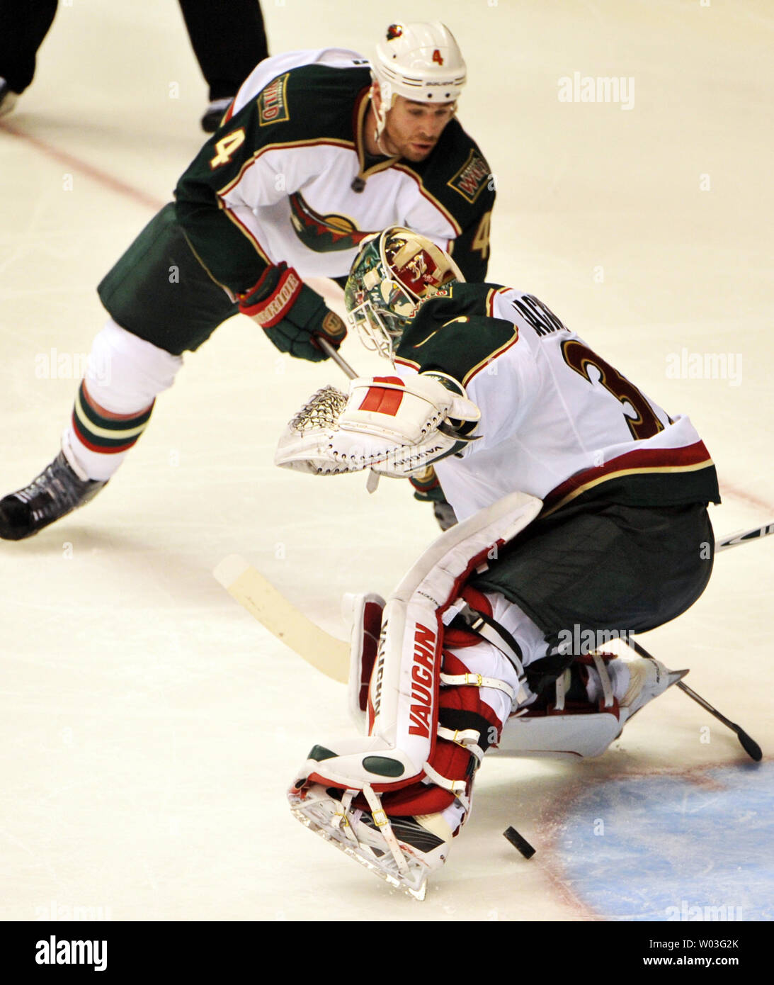 Minnesota Wild goalie Niklas Backstrom (R) has the puck slip through ...