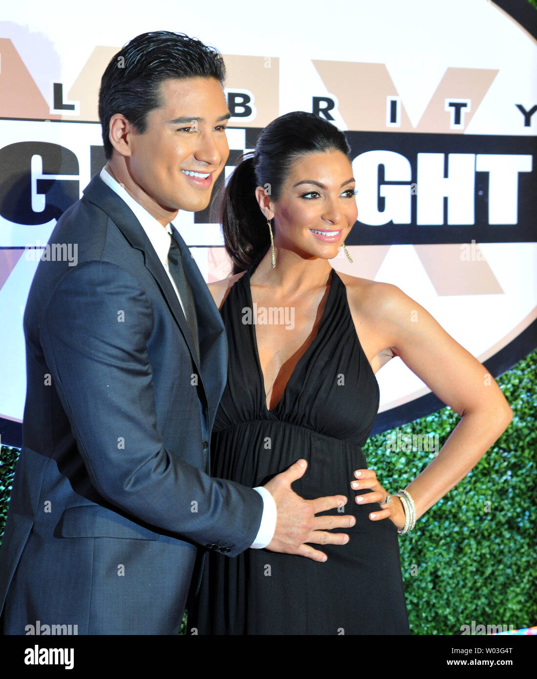 Actor Mario Lopez (L) shows off that Courtney Mazza is pregnant as they ...