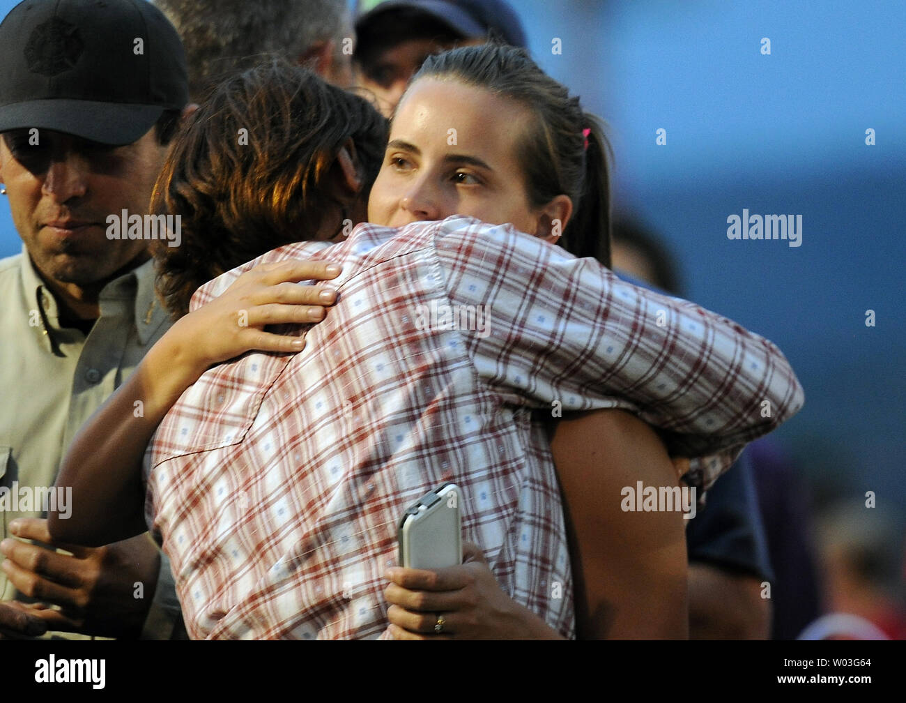Family members hug one another before a memorial service for the ...