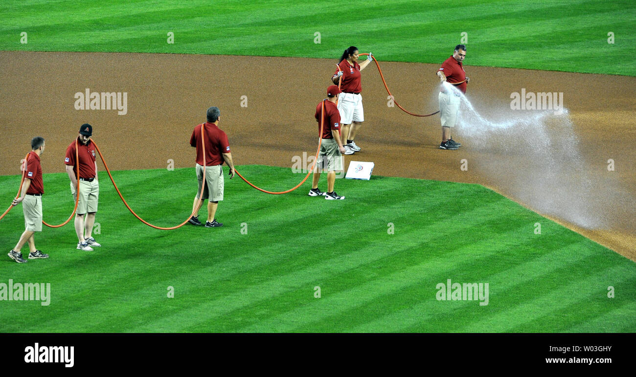 The Chase Field grounds crew water the infield before the Arizona ...
