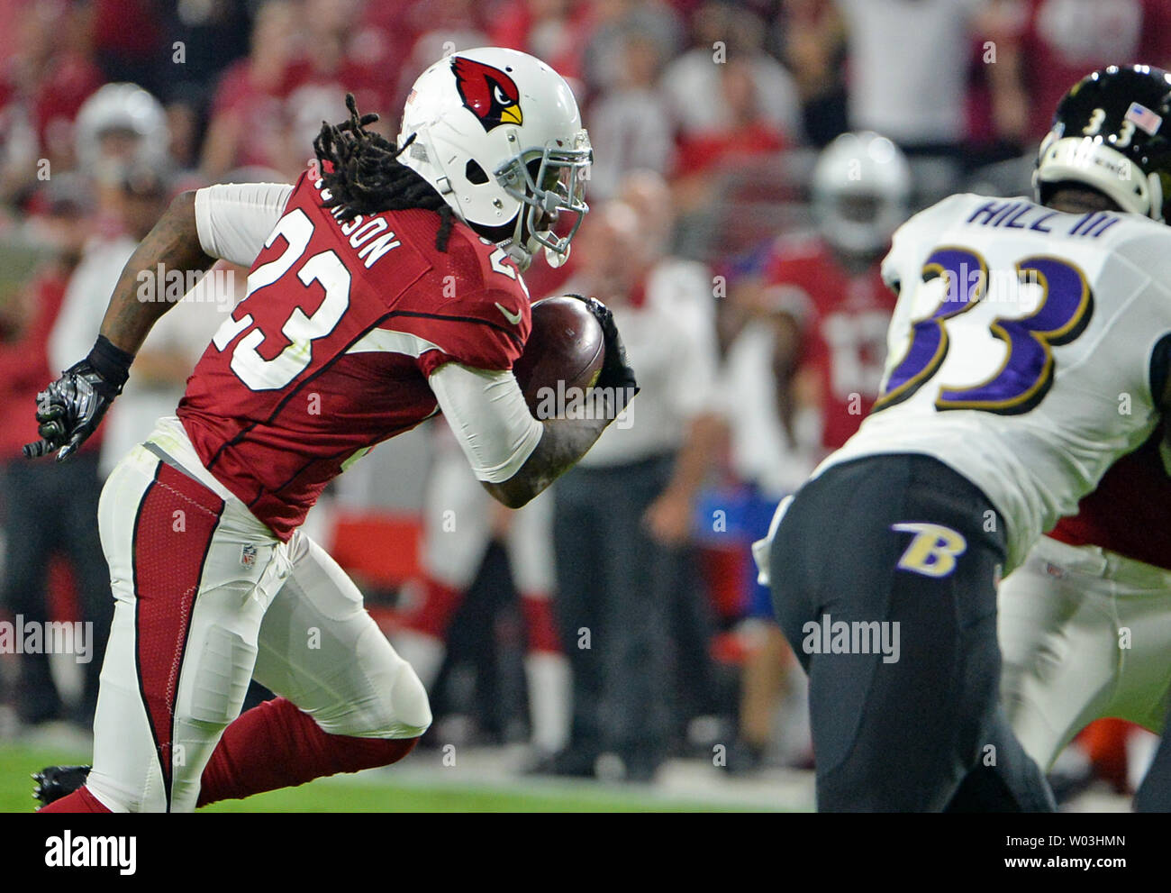 Arizona Cardinals running back Chris Johnson (L) heads to the end zone ...