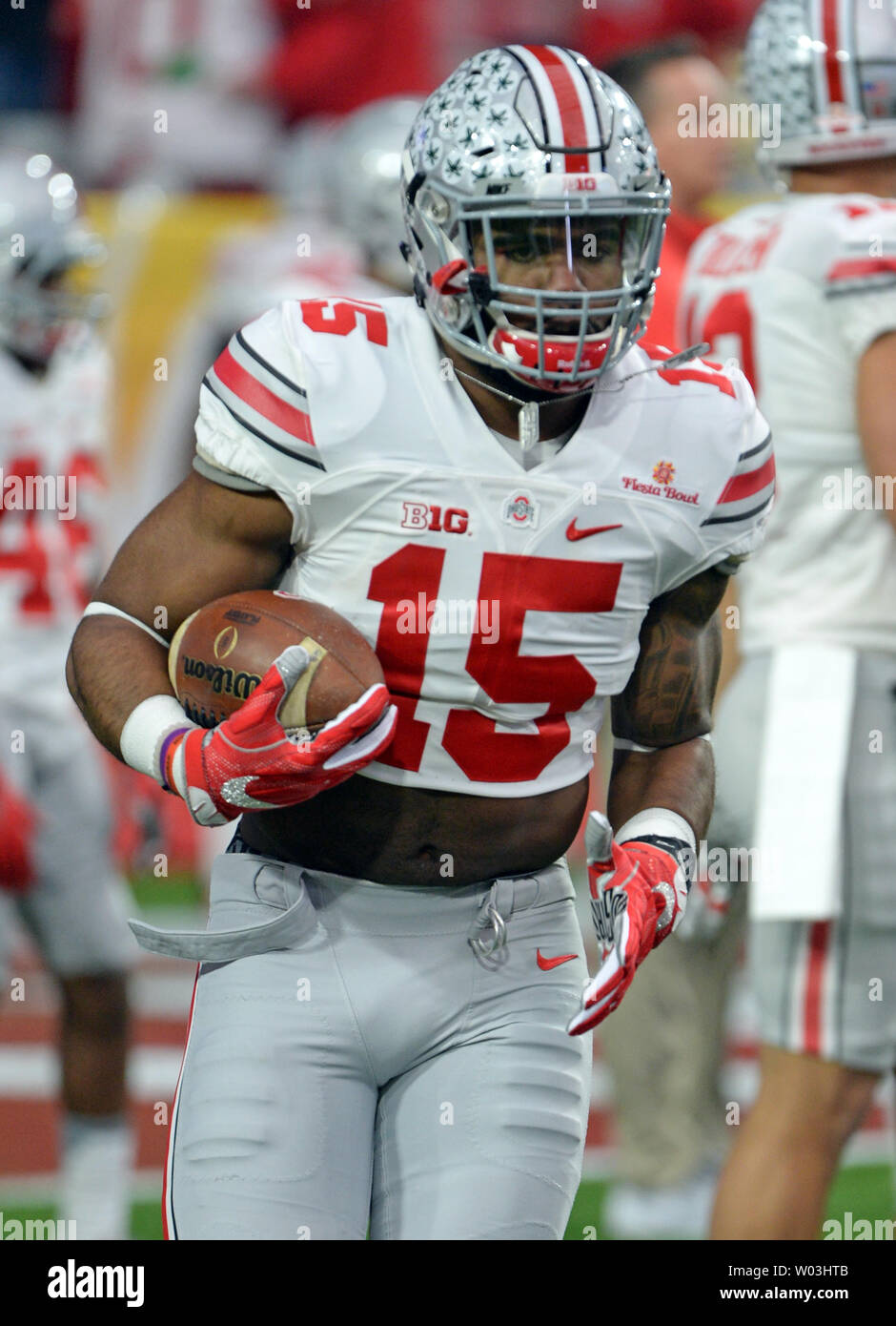 Ohio State running back Ezekiel Elliott runs with the ball as he warms ...