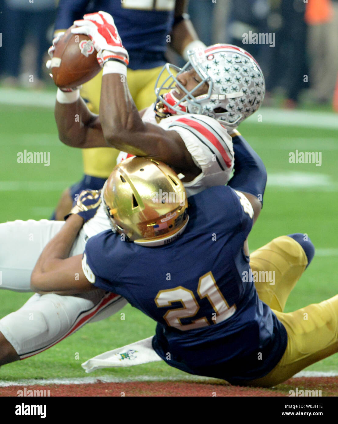 Ohio State Michael Thomas (T) holds on to the ball as he enters the end ...