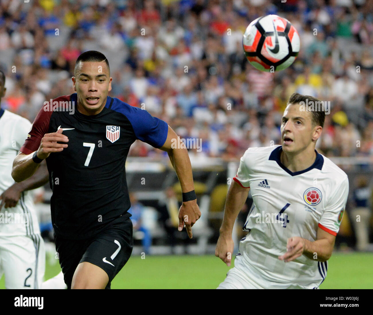 USA's Bobby Wood and Columbia"s Santiago Arias follow the ball in the ...