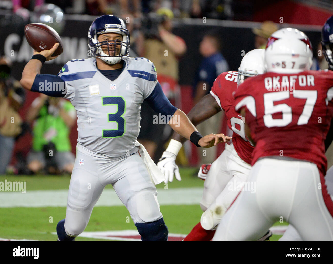 Seattle Seahawks' quarterback Russell Wilson (L) throws a pass in the ...