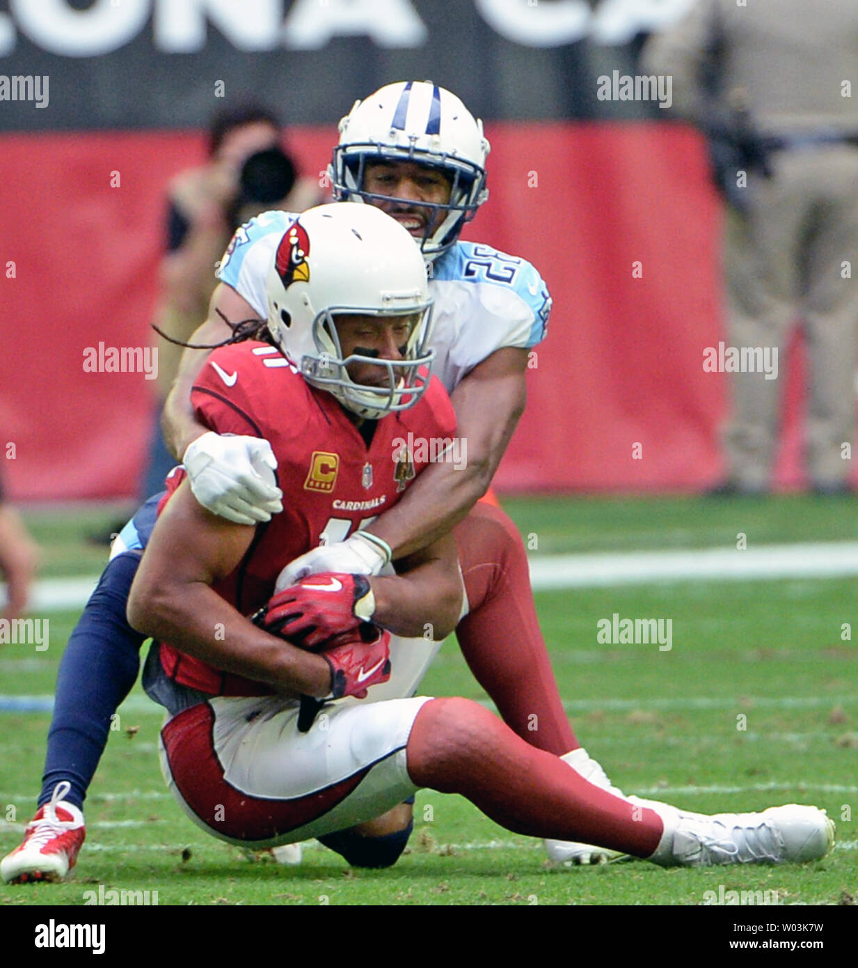 Arizona Cardinals' Larry Fitzgerald (11) is tackled by Tennessee Titans ...