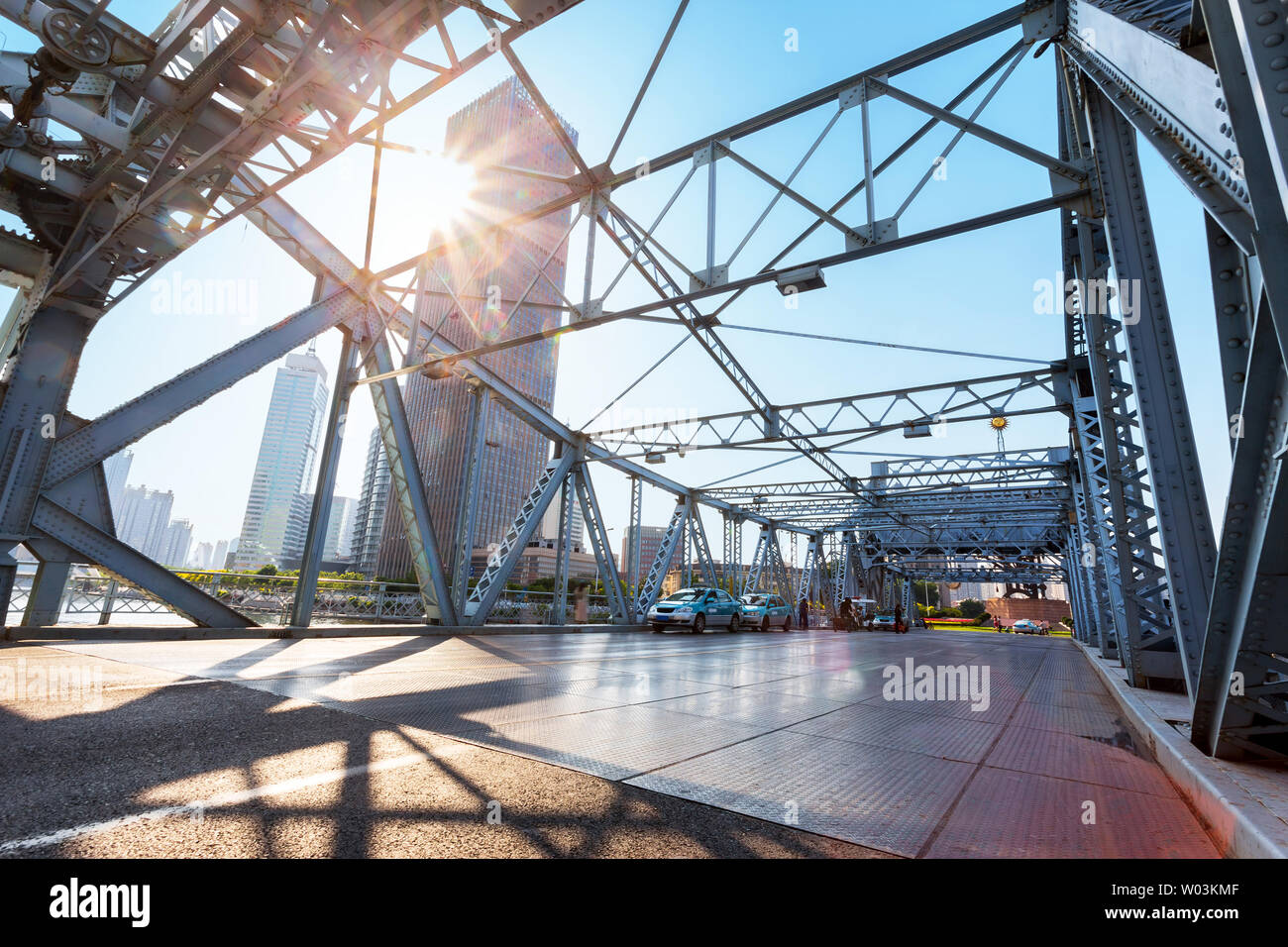 Traffic on steel bridge interior and skyline at sunset Stock Photo - Alamy