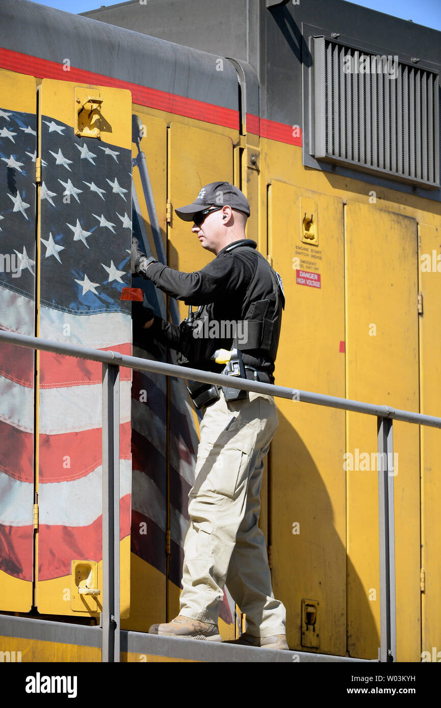 A member of the Union Pacific Railroad police checks out compartments ...