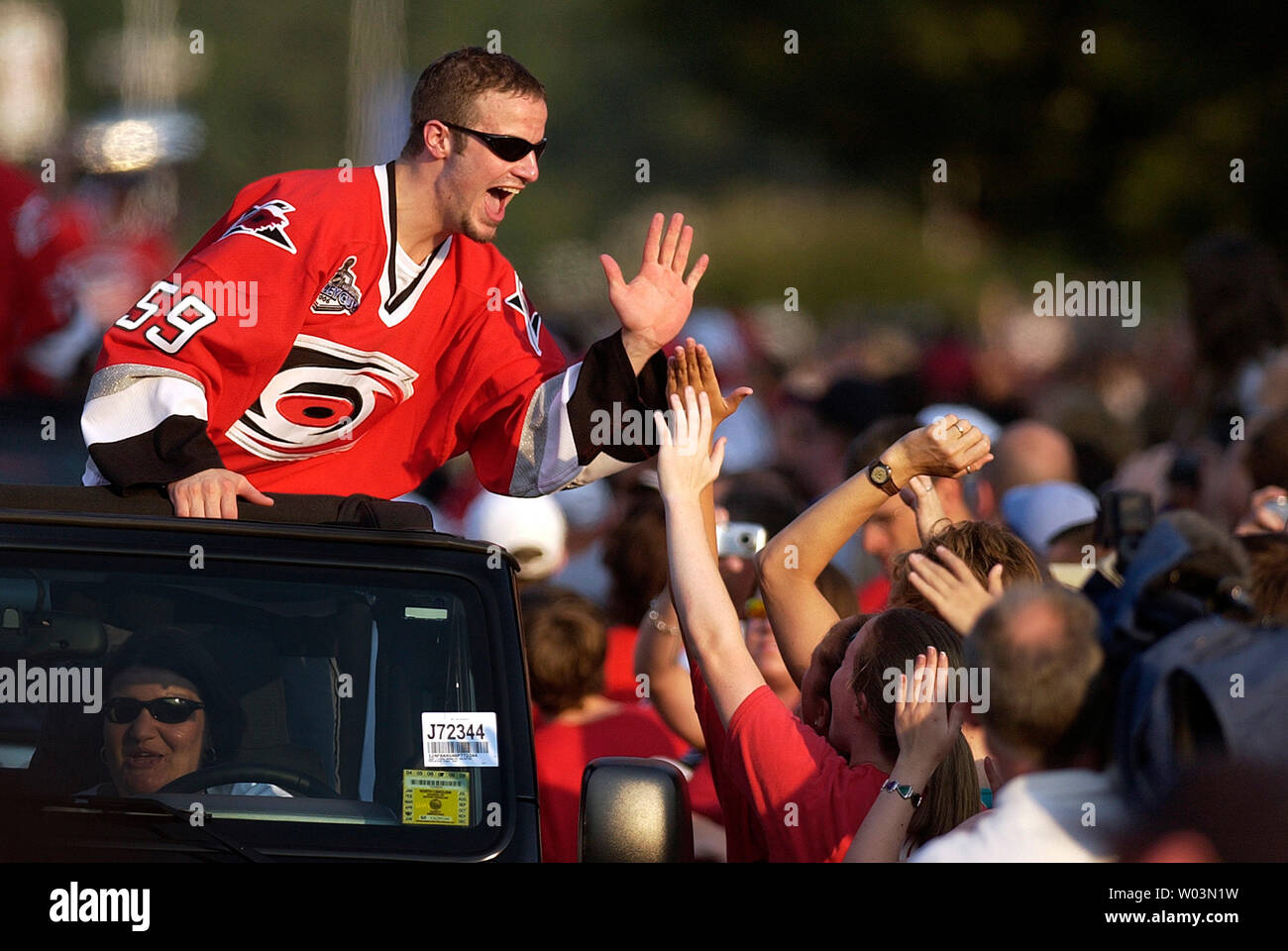 Carolina Hurricanes' Chad LaRose high-fives with fans during a parade ...