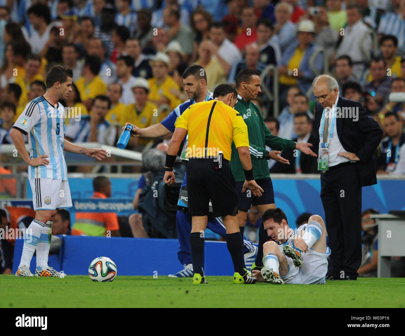Lionel Messi of Argentina lies injured during the 2014 FIFA World Cup ...