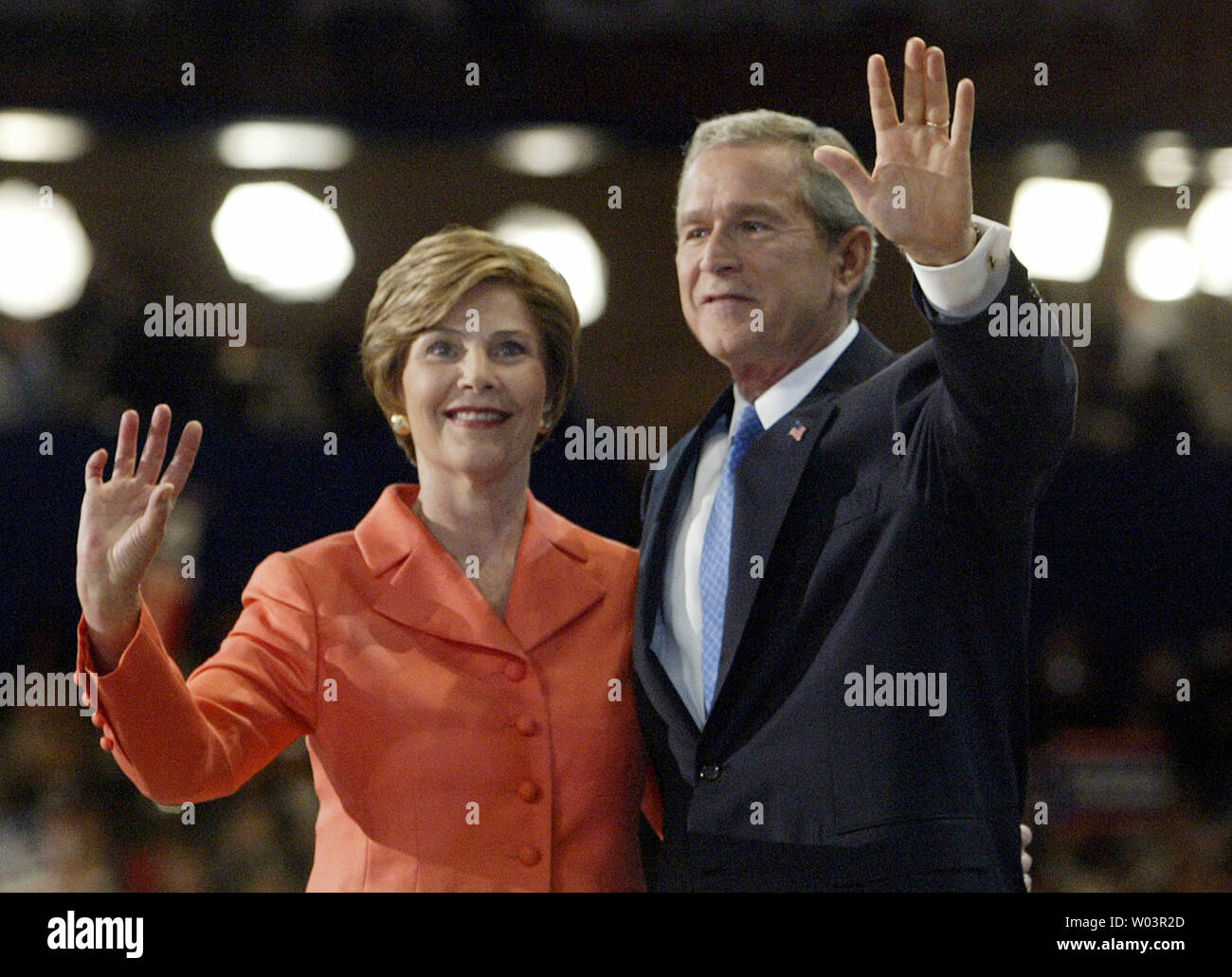 President George Bush and First Lady Laura Bush wave to supporters ...