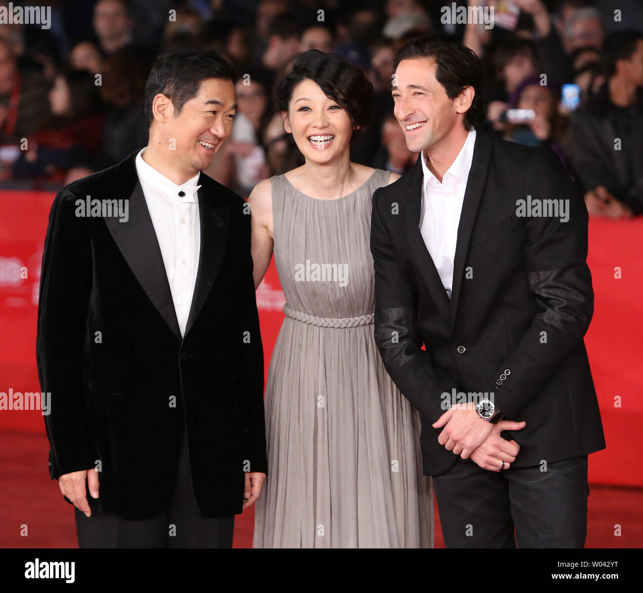 Zhang Guo Li (L), Xu Fan (C) and Adrien Brody arrive on the red carpet for the film "Back To ...