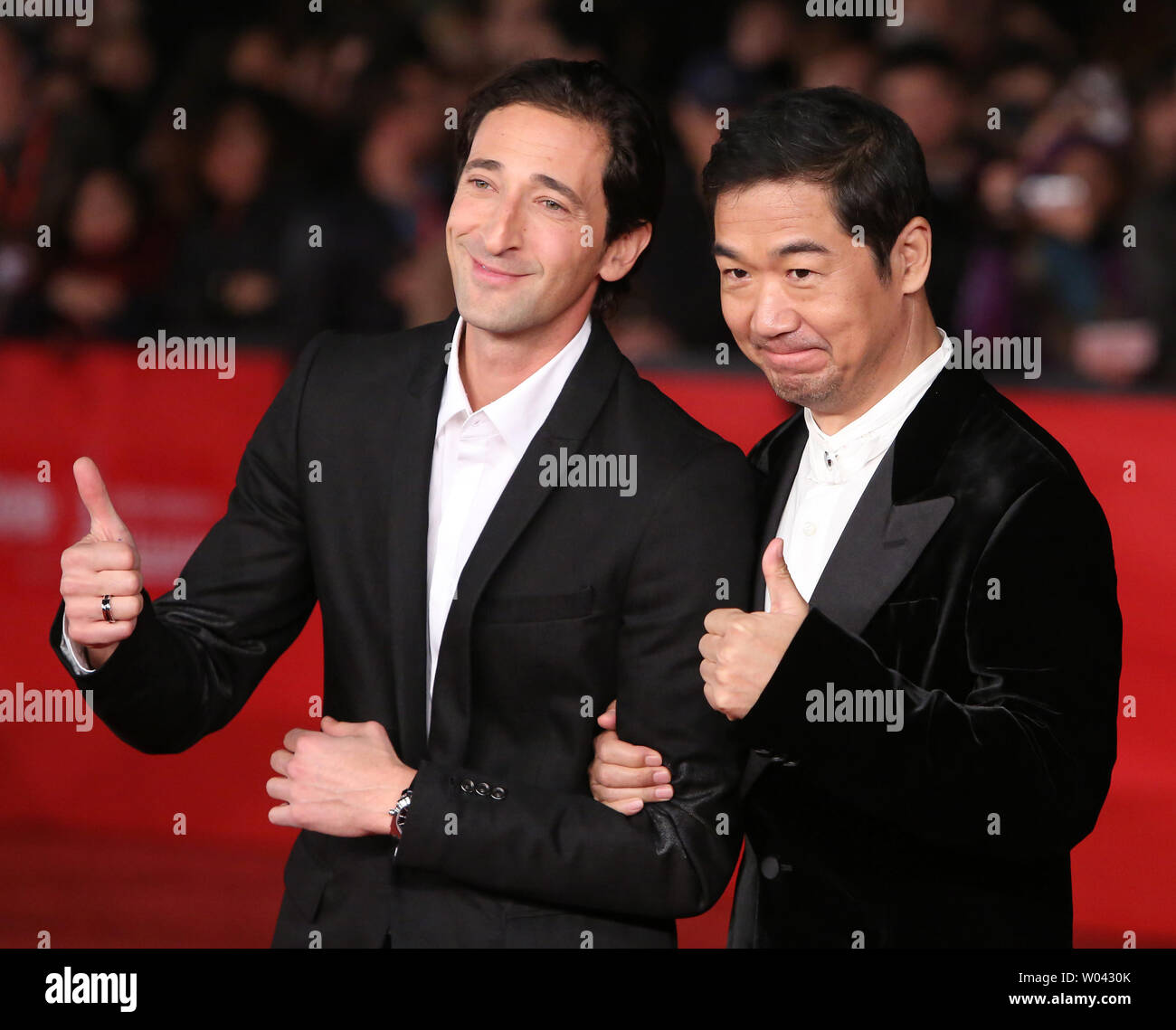Adrien Brody (L) and Zhang Guo Li arrive on the red carpet for the film "Back To 1942" during ...