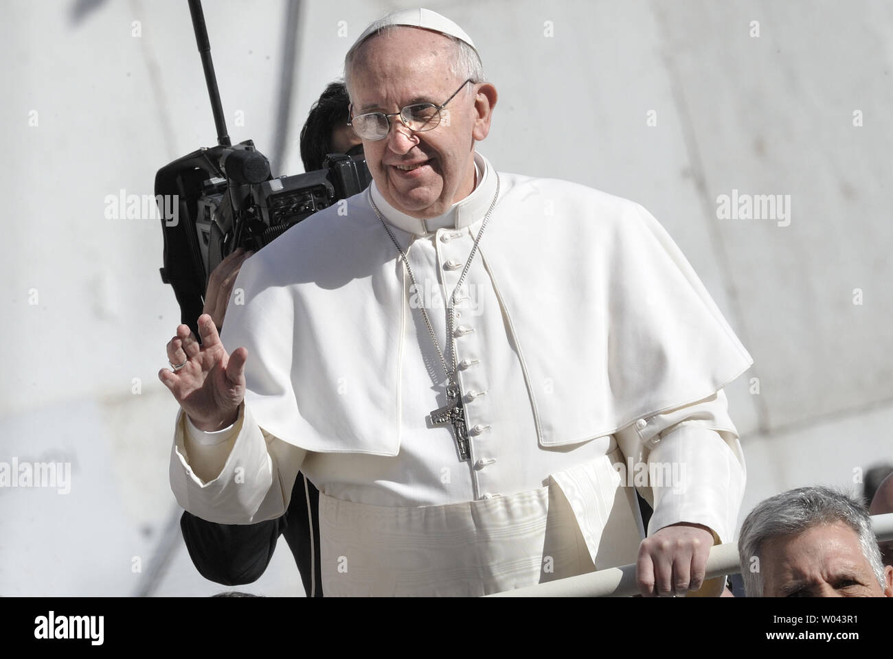 Pope Francis waves from the papamobile as he arrives for his ...