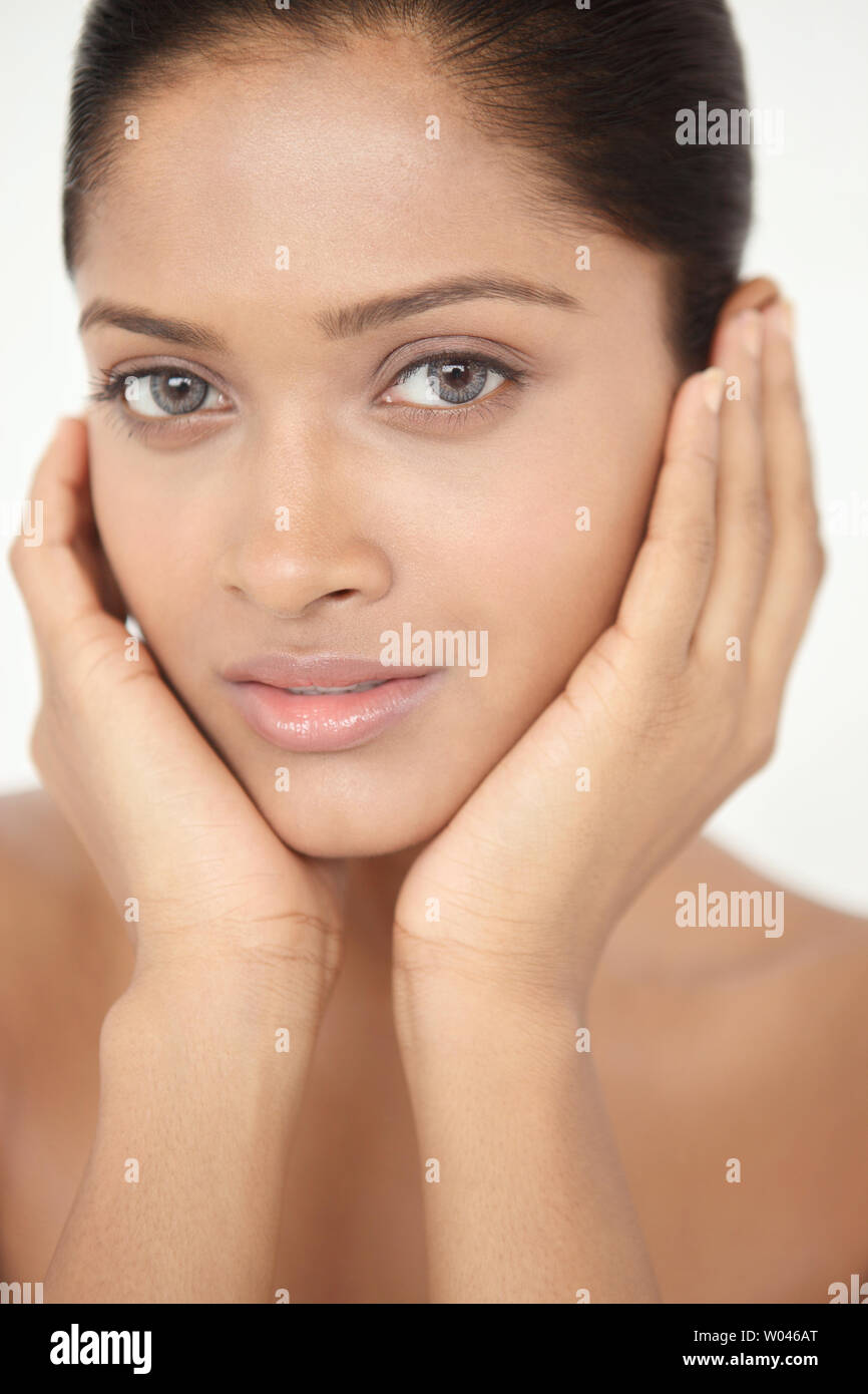 Portrait of an Indian woman touching her cheeks Stock Photo - Alamy