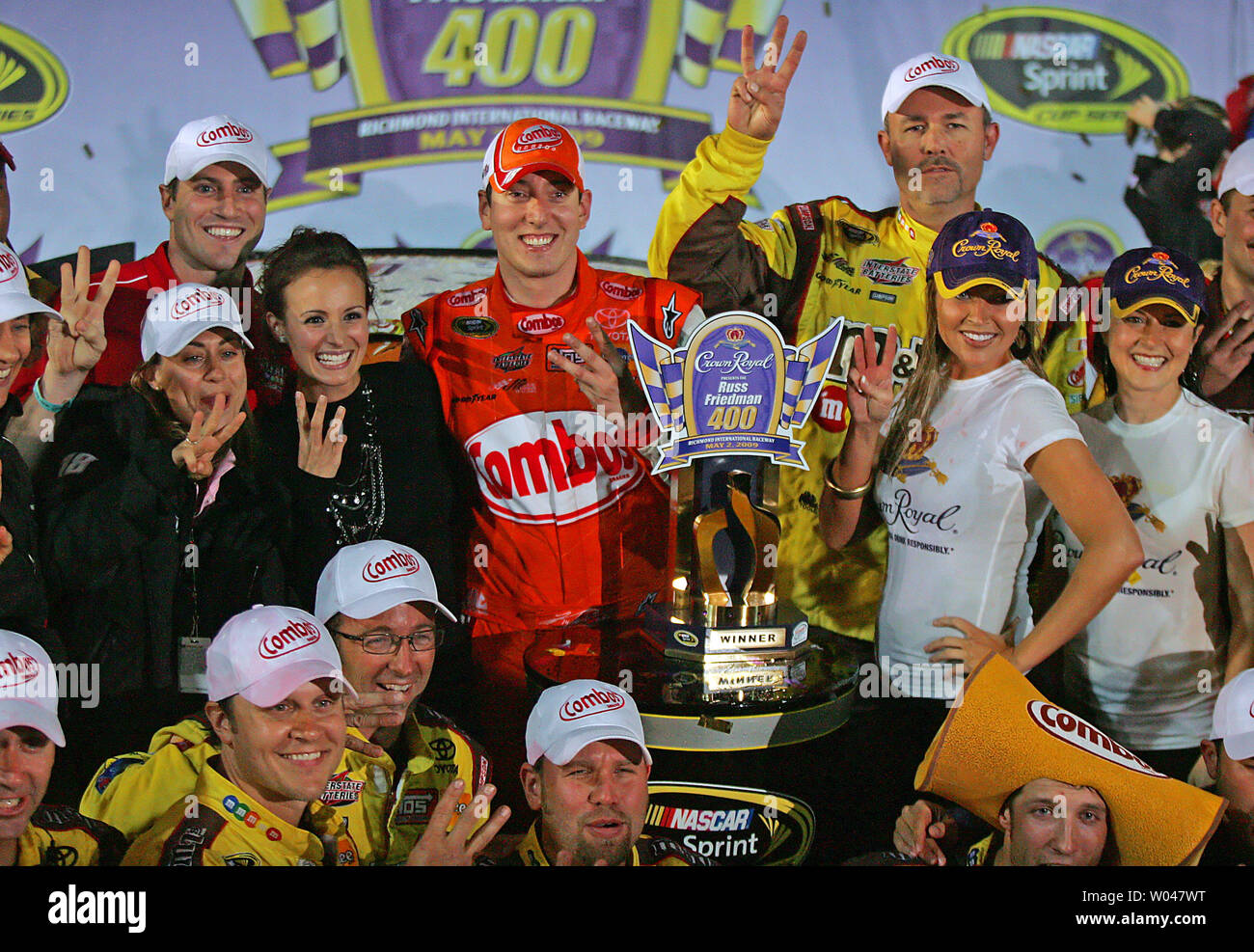 Kyle Busch poses with the trophy following his win in the NASCAR Crown ...
