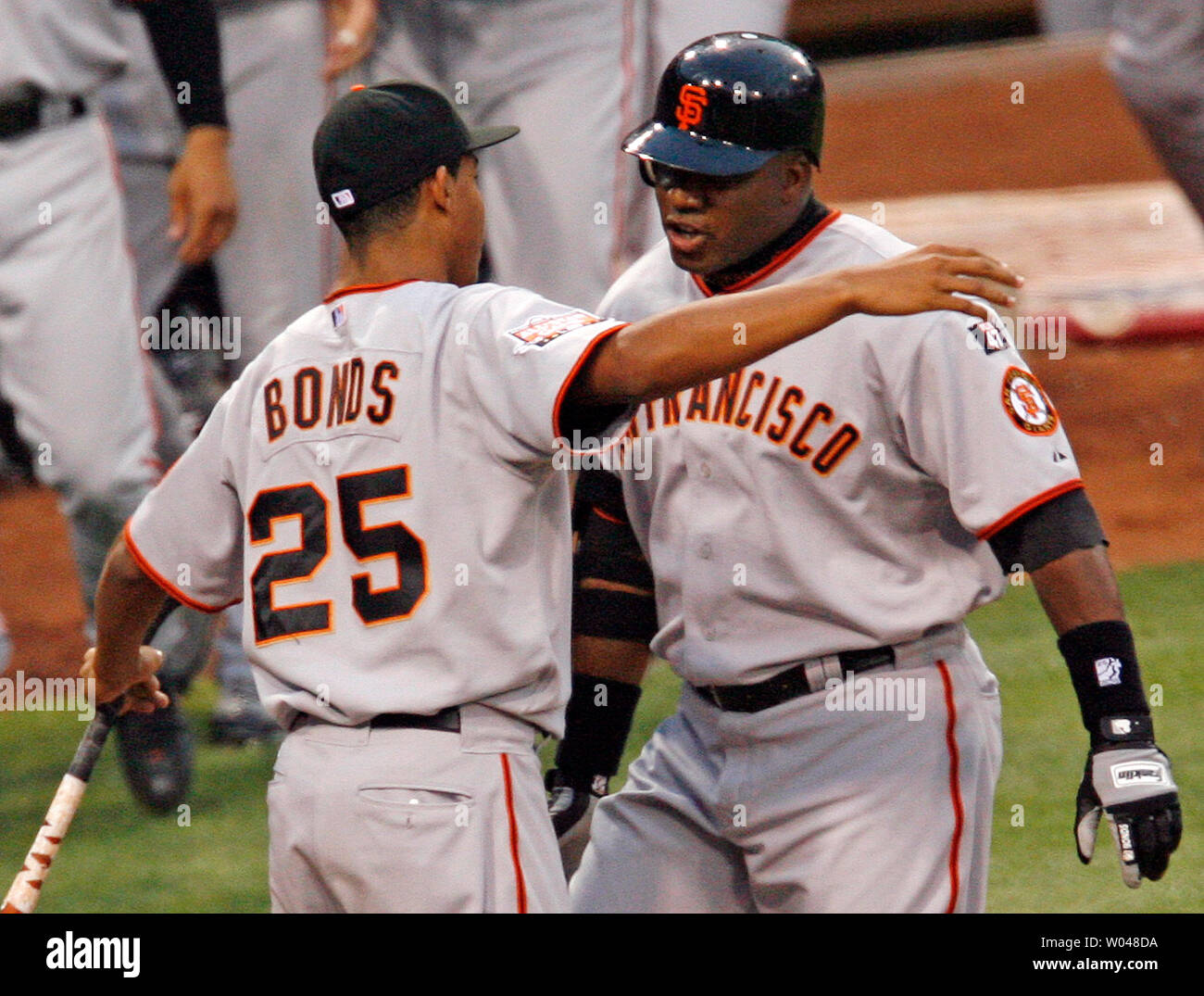Nikolai Bonds (L) reaches out to hug his father, San Francisco Giants ...