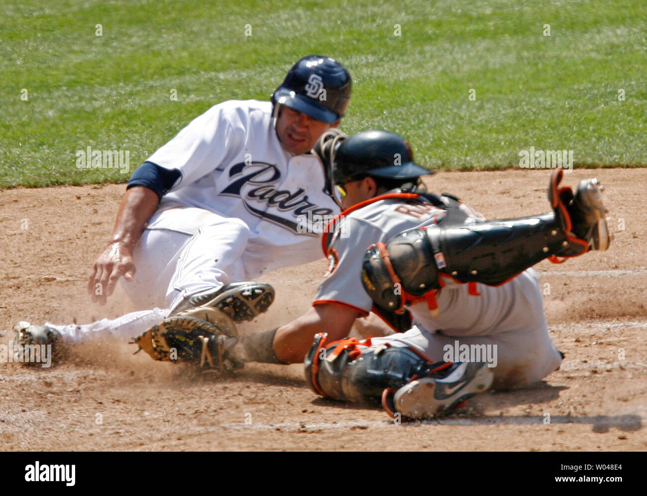San Diego Padres runner Rob Mackowiak (L) scores from third base ...