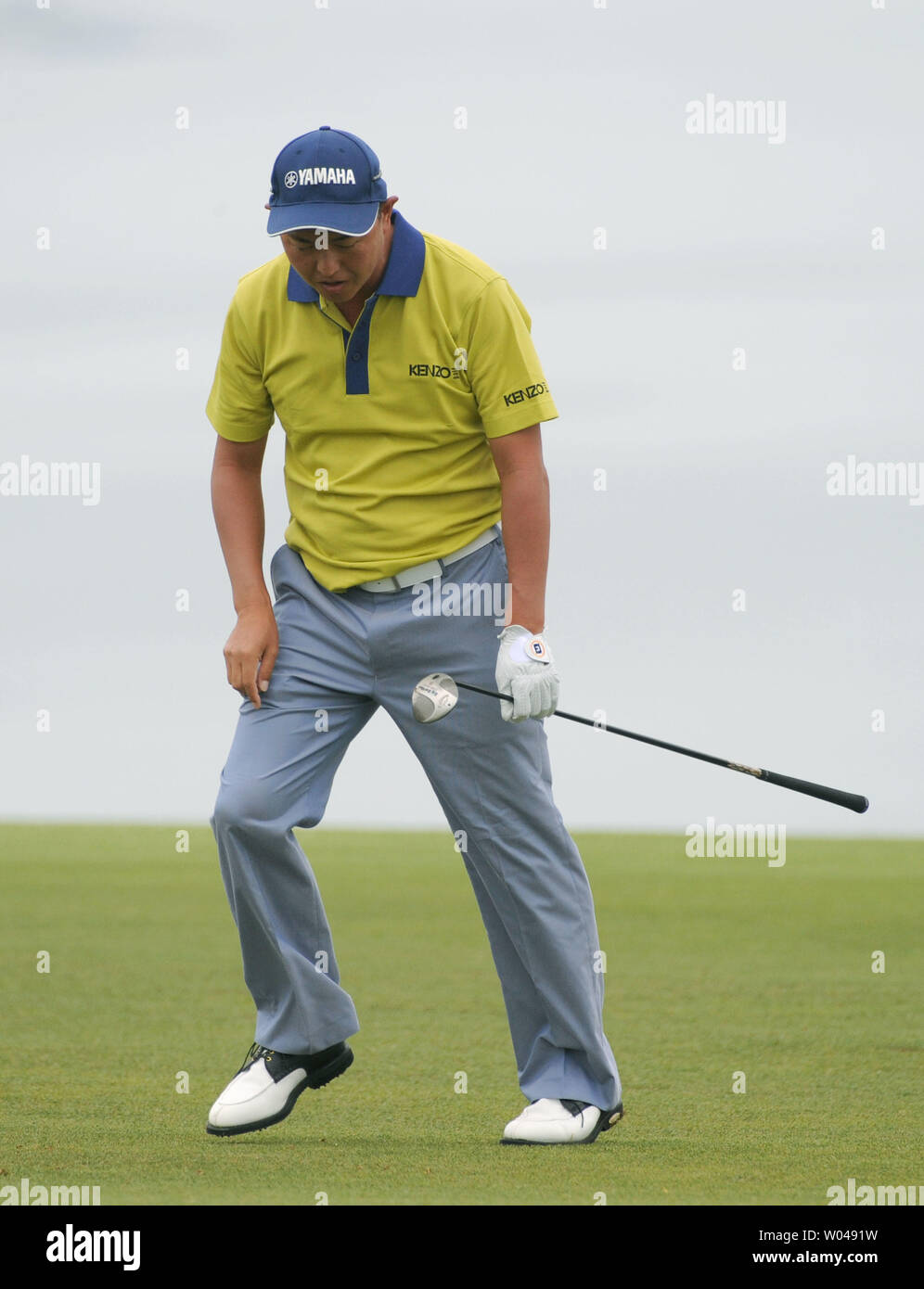 Toru Taniguchi, of Japan,reacts after hitting on the 4th fairway during ...