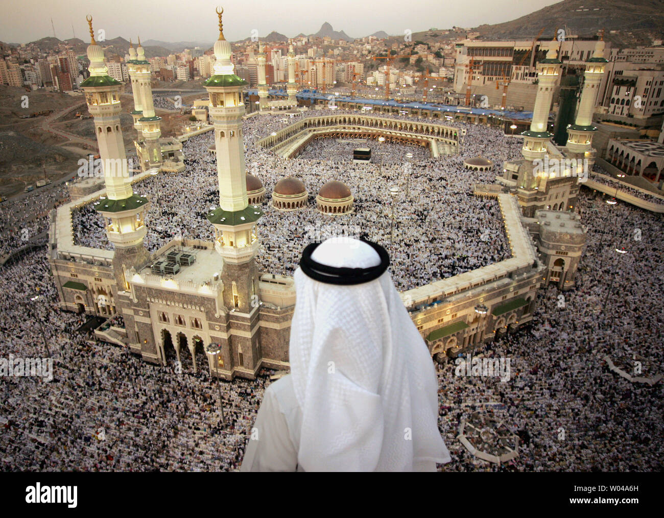 Ghassan, a Saudi officer, looks at Muslims pilgrims while they pray at ...