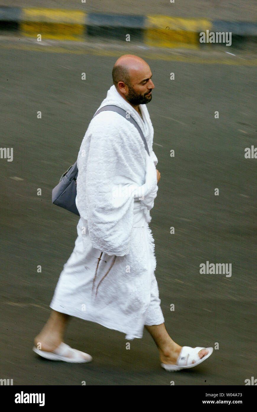A Muslim pilgrim wears Ihram, special clothes for Hajj, as he makes his ...